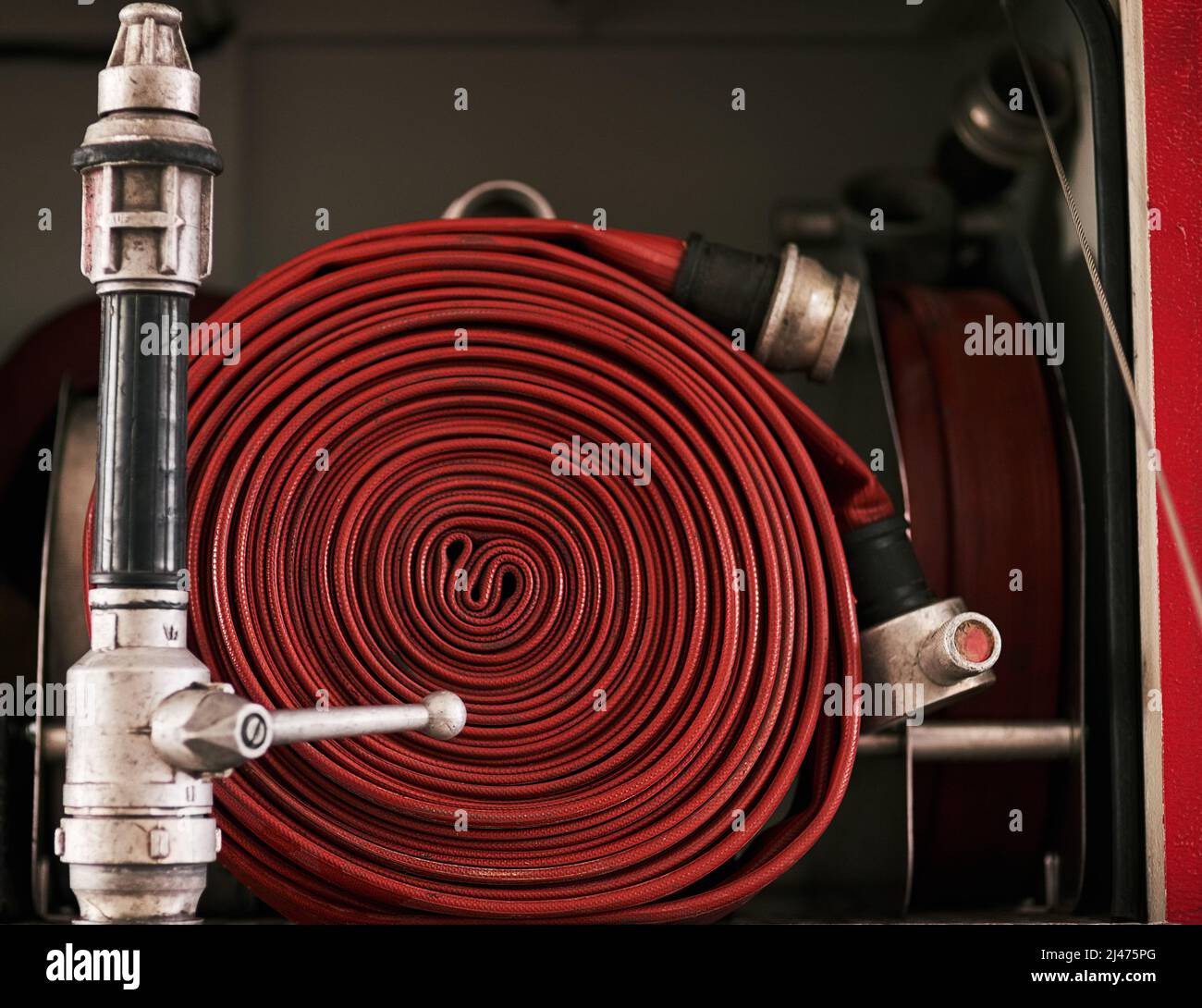 Behind the scenes at the fire station. Cropped shot of a coiled fire ...
