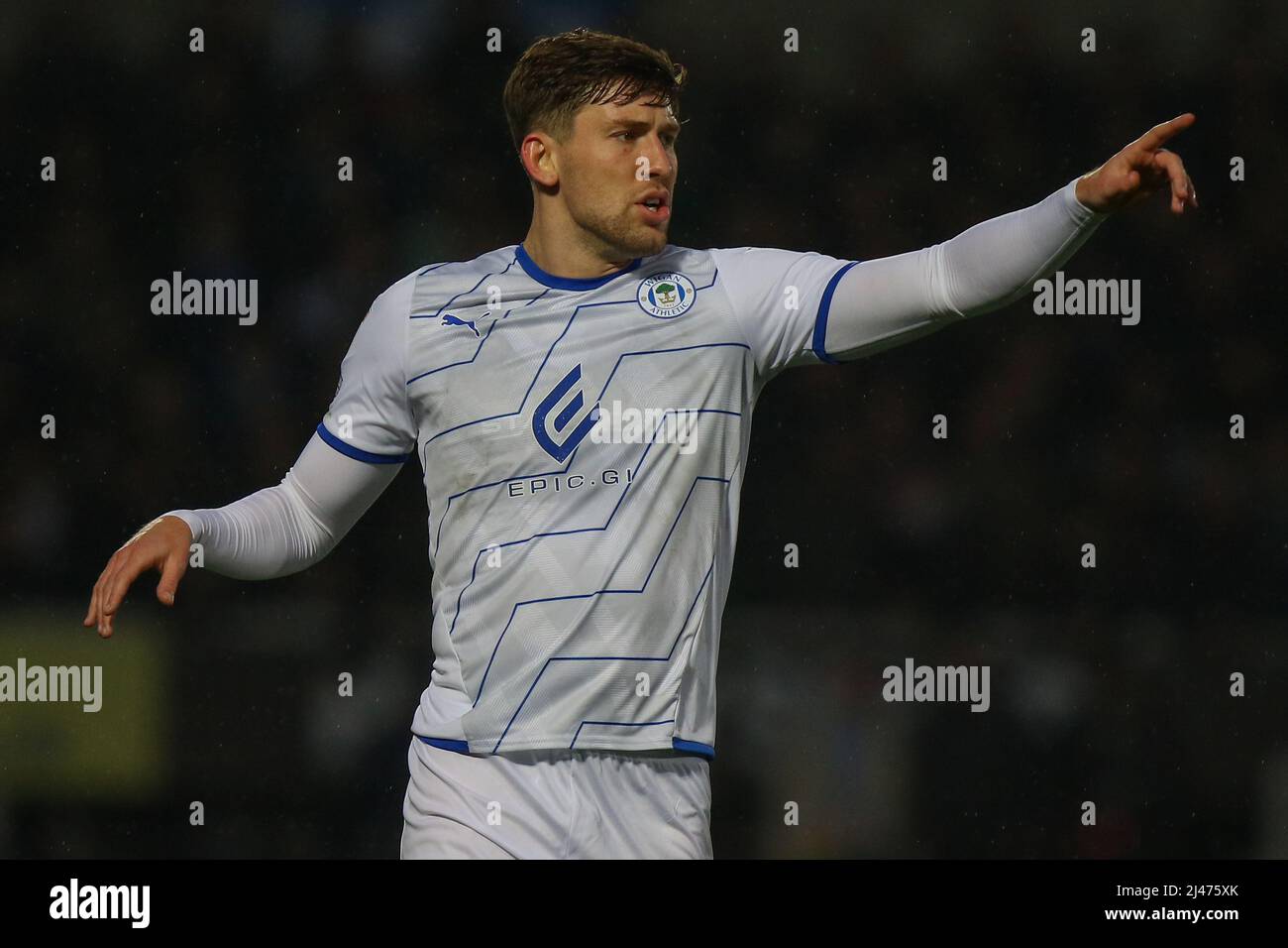 Callum Lang #19 of Wigan Athletic gives instructions to his team mates ...