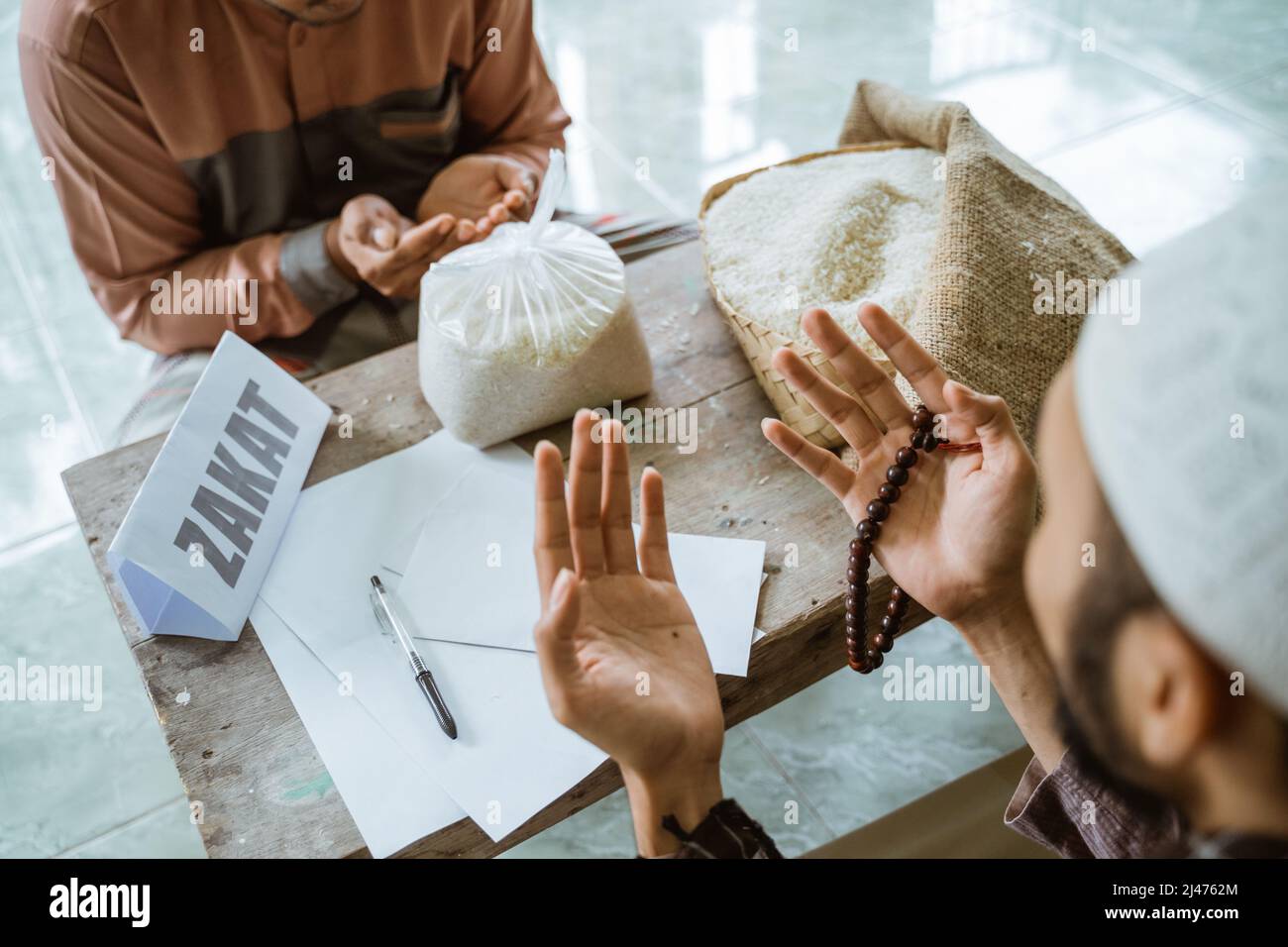 asian man paying zakat at the mosque and praying thanking god Stock ...