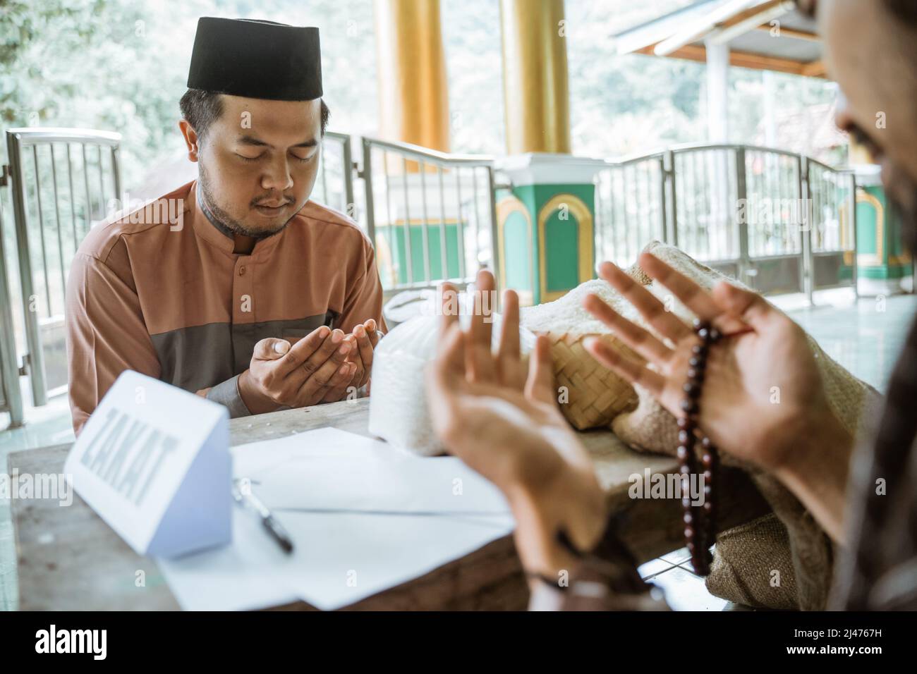 asian man paying zakat at the mosque and praying thanking god Stock ...