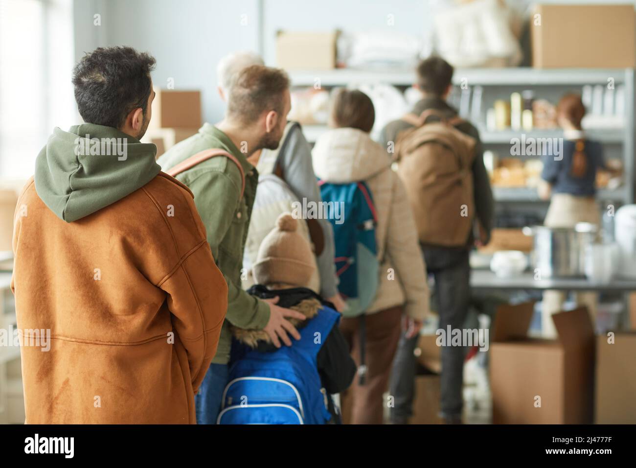 Background image of Caucasian refugees in line at donation center ...