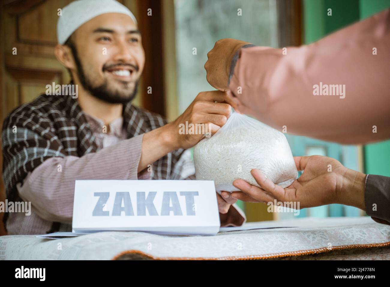 man giving a rice as a food donation for zakat during eid mubarak Stock ...