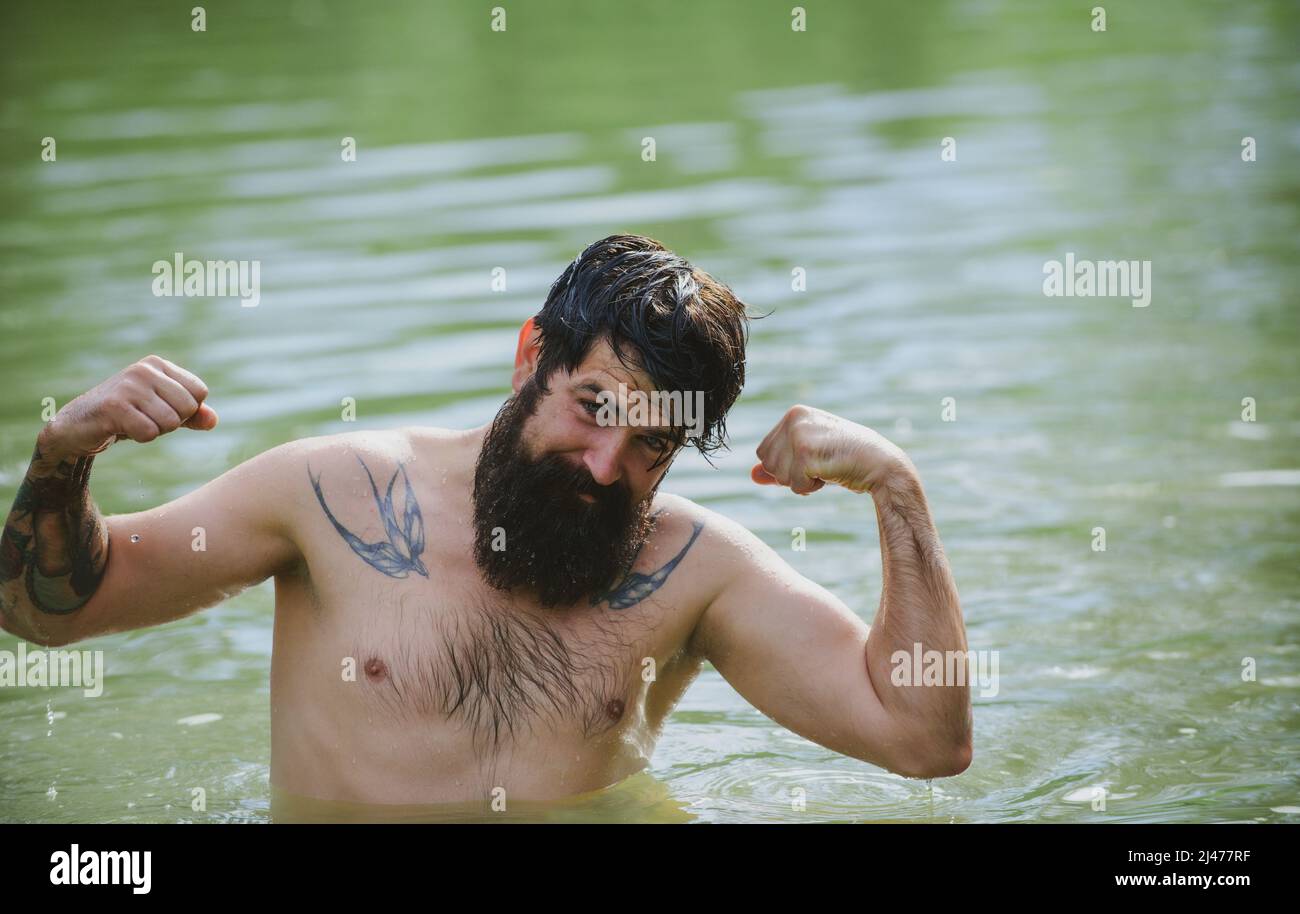 Bearded man on summer holidays. Male swimming in water. Having fun ...