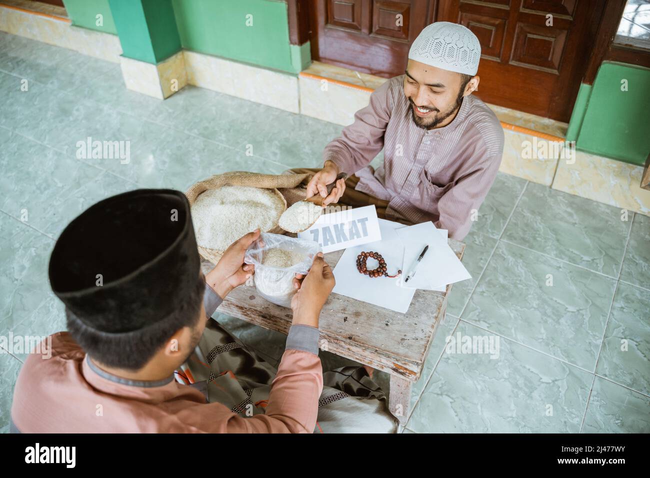rice donation in zakat during eid mubarak kareem Stock Photo - Alamy