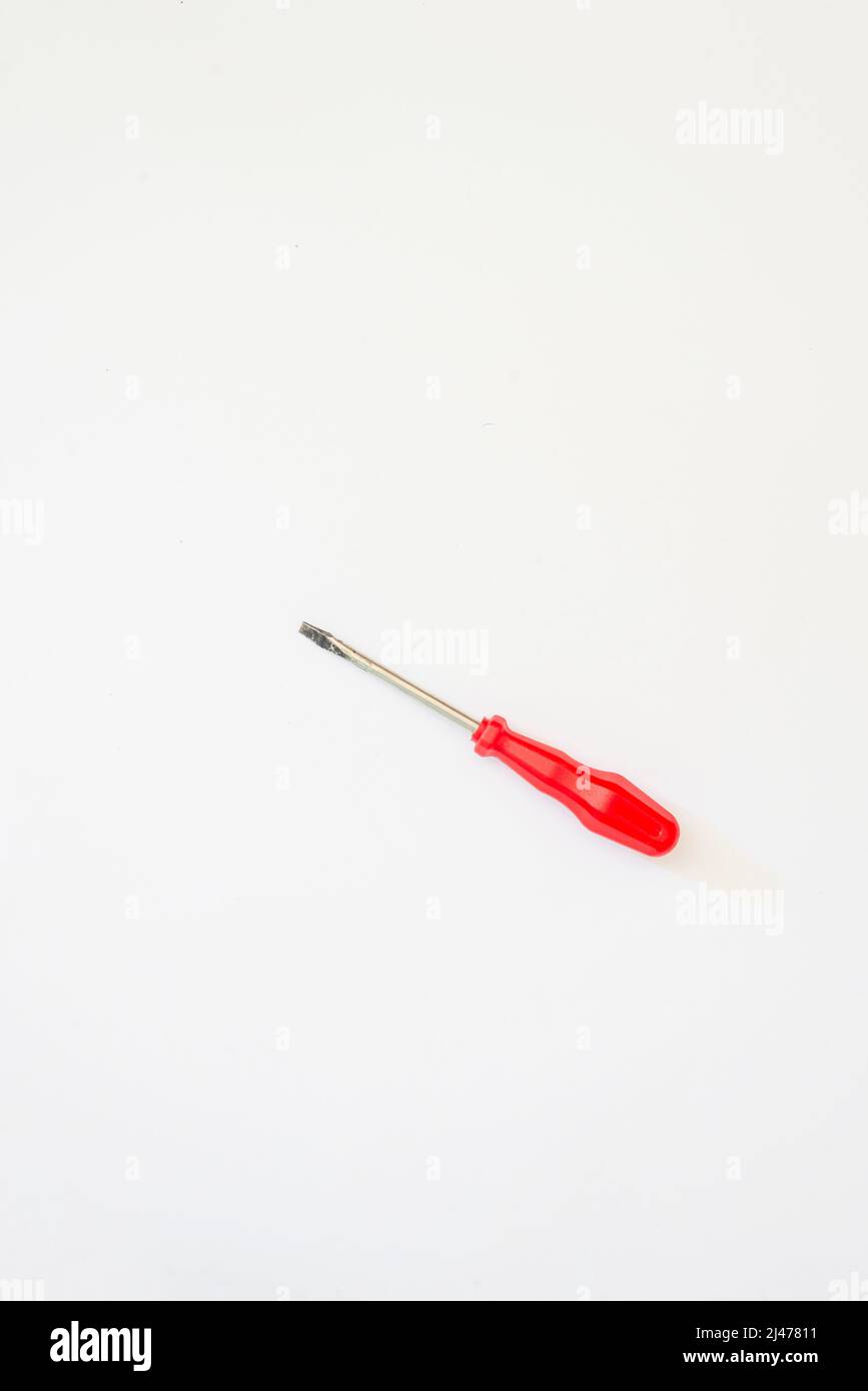 Small screwdriver of red color on a white background. Salvador, Bahia ...