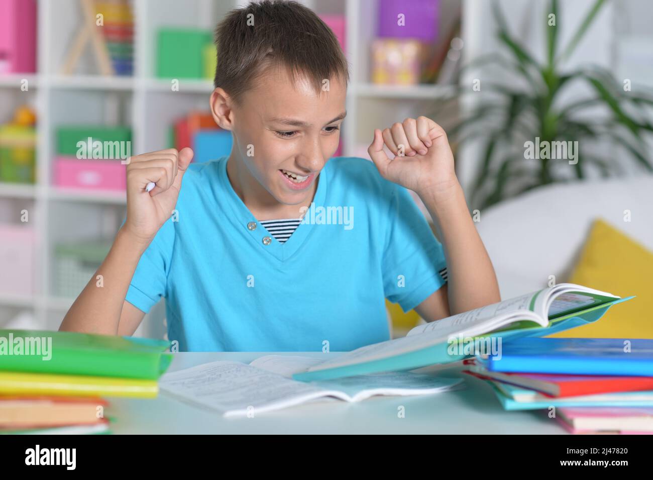 Cute boy doing homework at home Stock Photo - Alamy