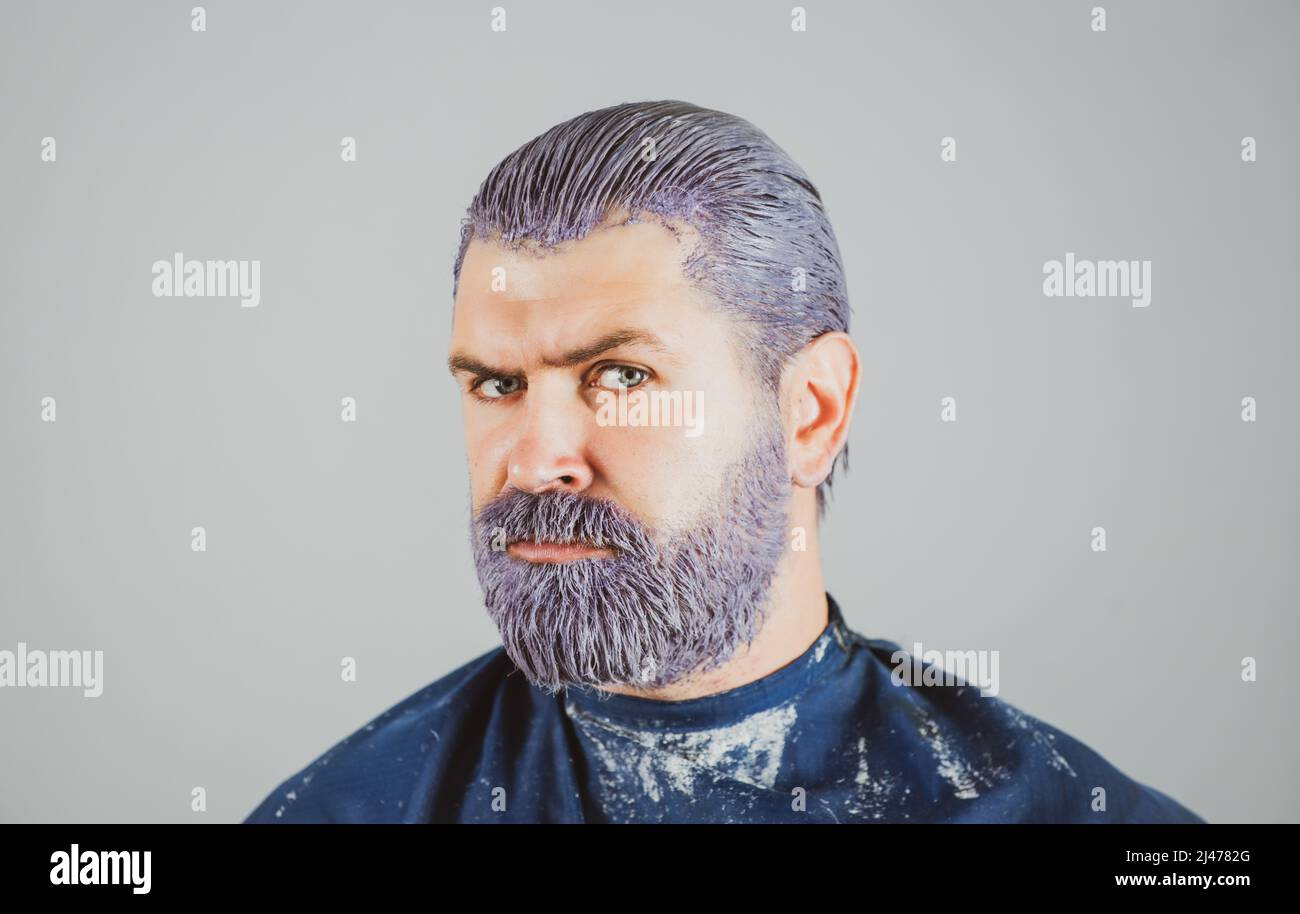 Man hair coloring. Bearded hipster guy. Process of a man having his ...
