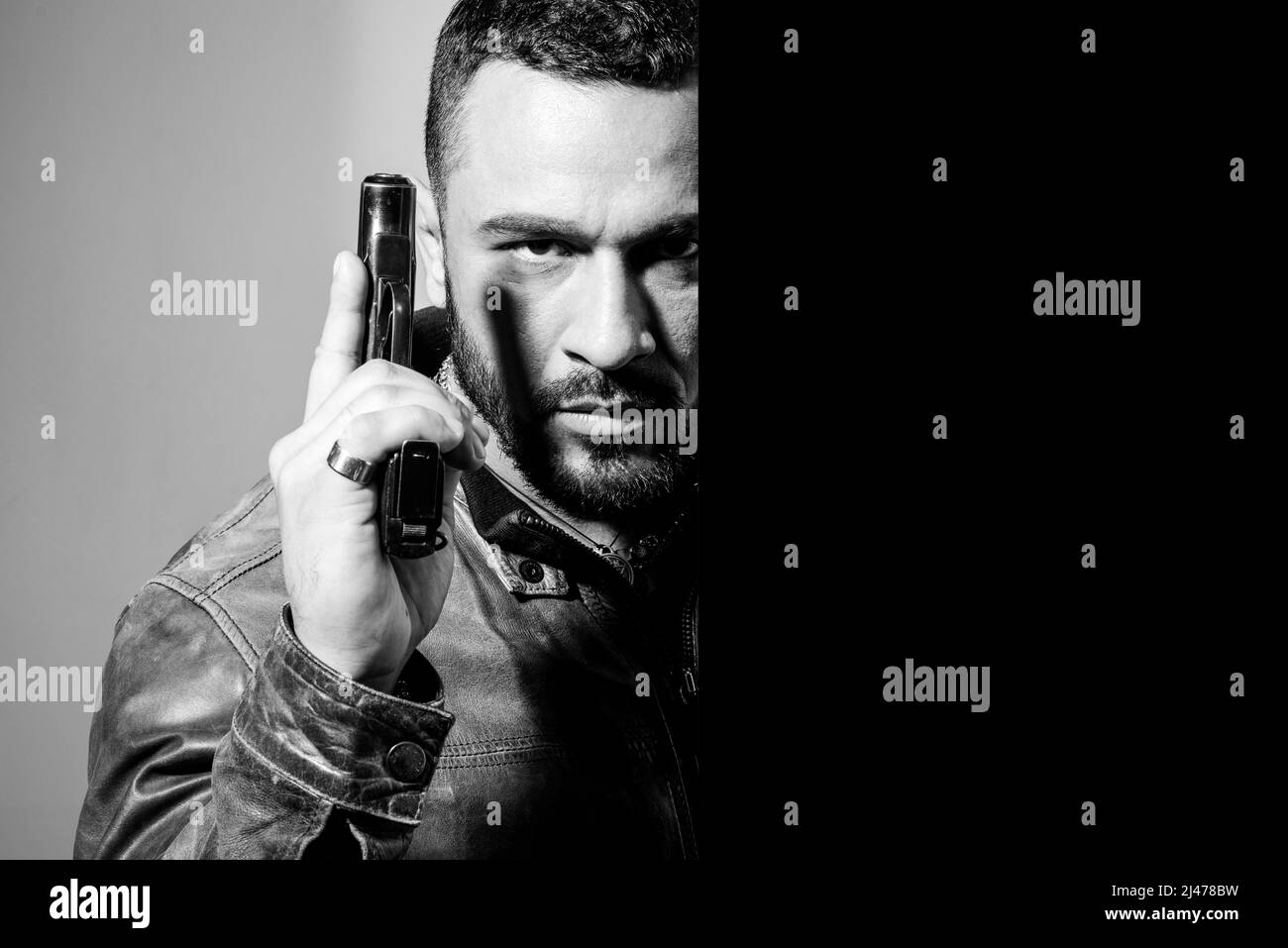 Portrait of a man holding gun. Handsome bearded man. Danger. Gunman ...