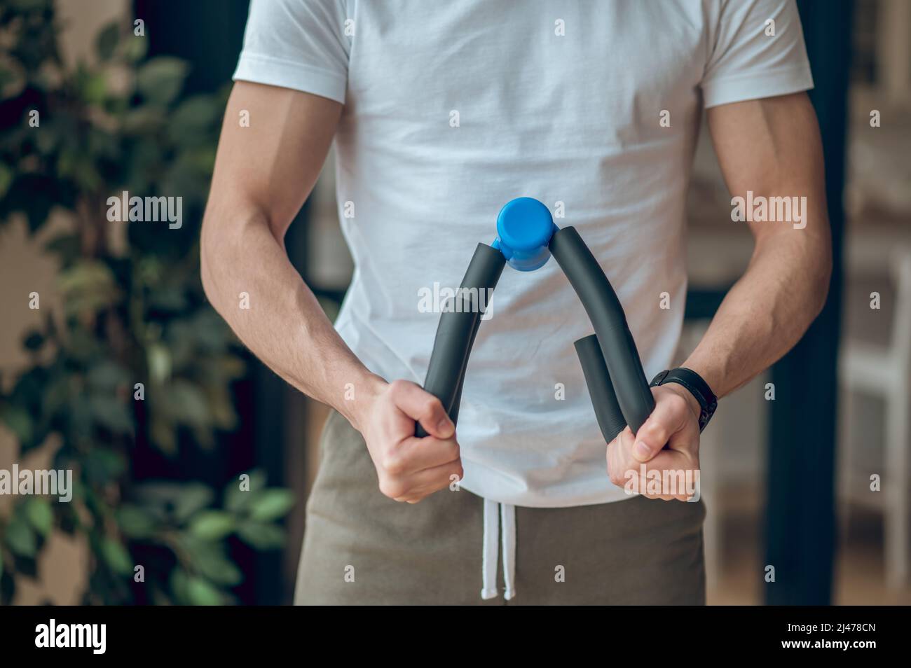 Young man exercising expander hi-res stock photography and images - Alamy