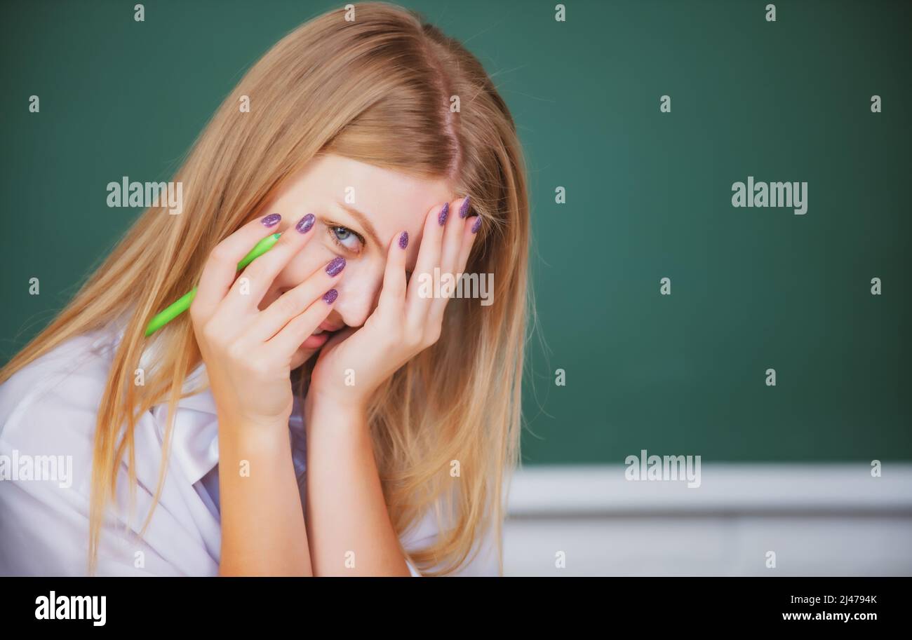 Portrait of young female college shame embarrassed student classroom on ...
