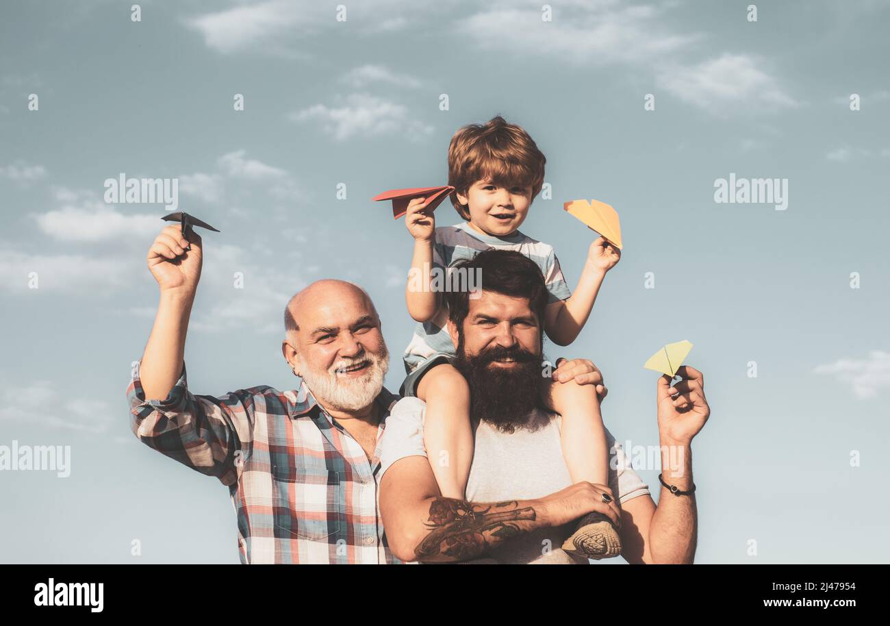 Leisure activity. Grandfather playtime. Happy smiling boy on shoulder ...