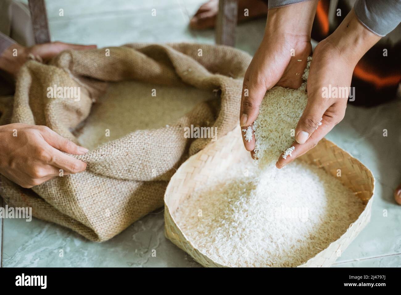 Hands giving rice grains for zakat helping the poor Stock Photo - Alamy
