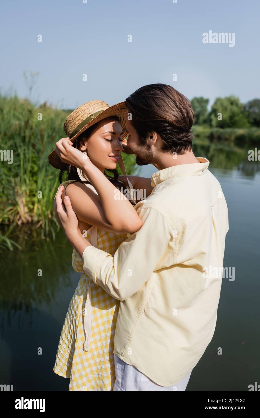 happy young couple in summer clothes hugging near lake Stock Photo - Alamy