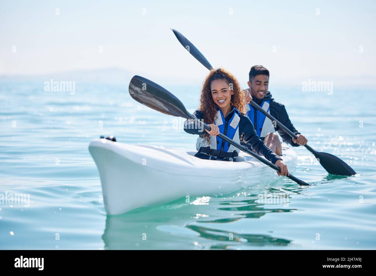 We row together, we grow together. Portrait of a young couple kayaking ...