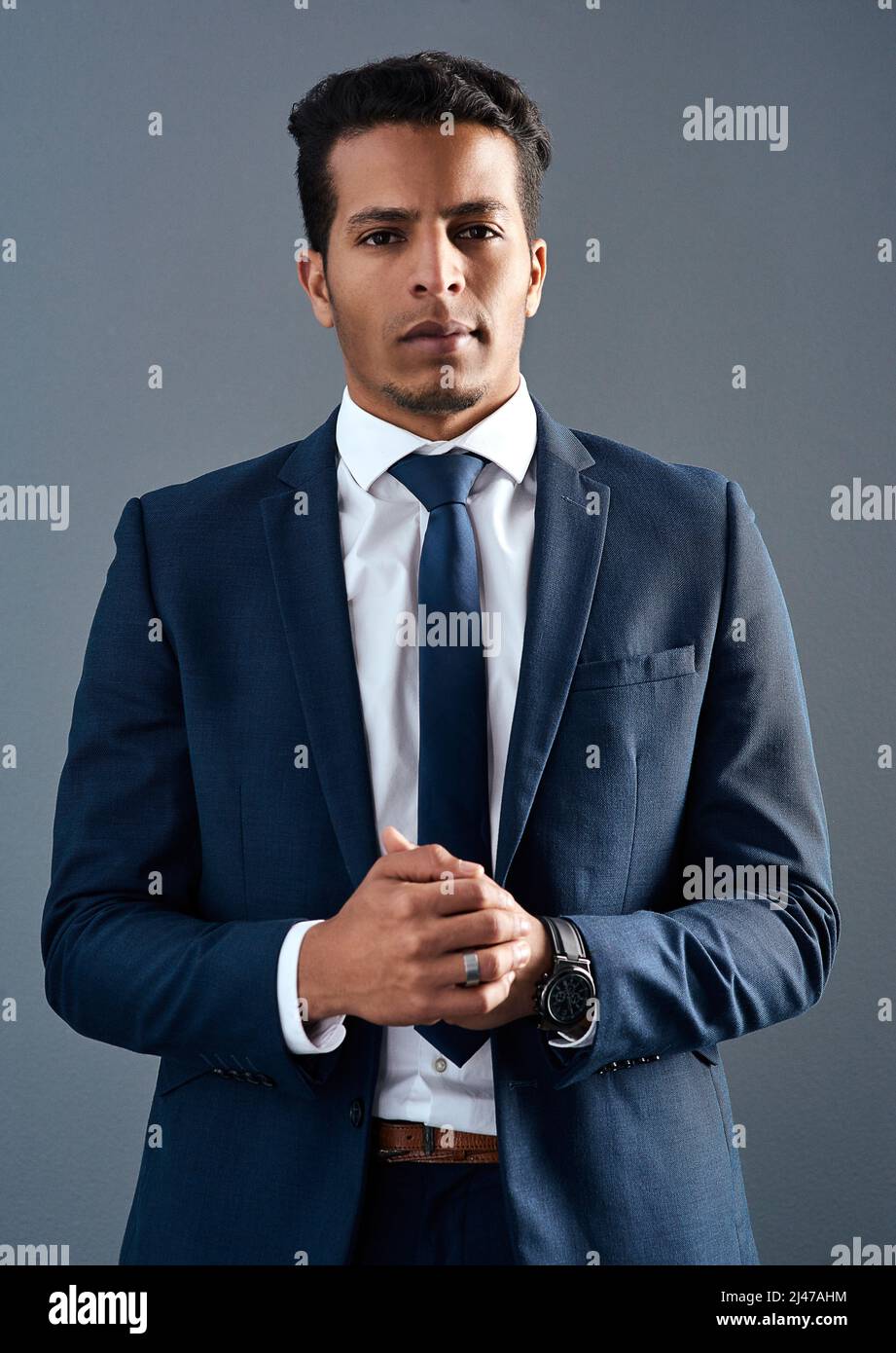 Its just business. Studio shot of a corporate businessman posing ...