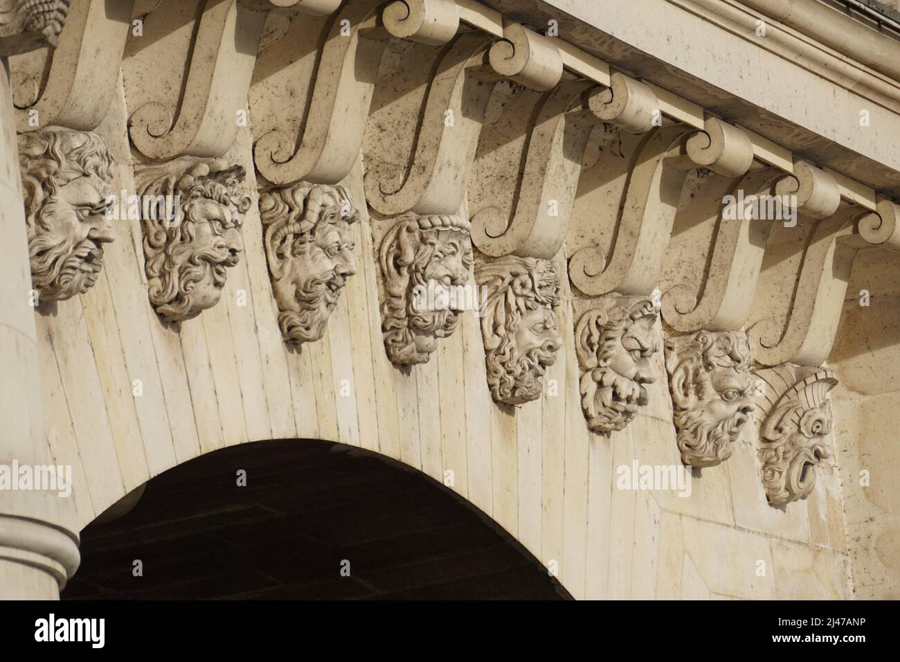 view of the carved faces on the Pont Neuf in downtown Paris, France ...
