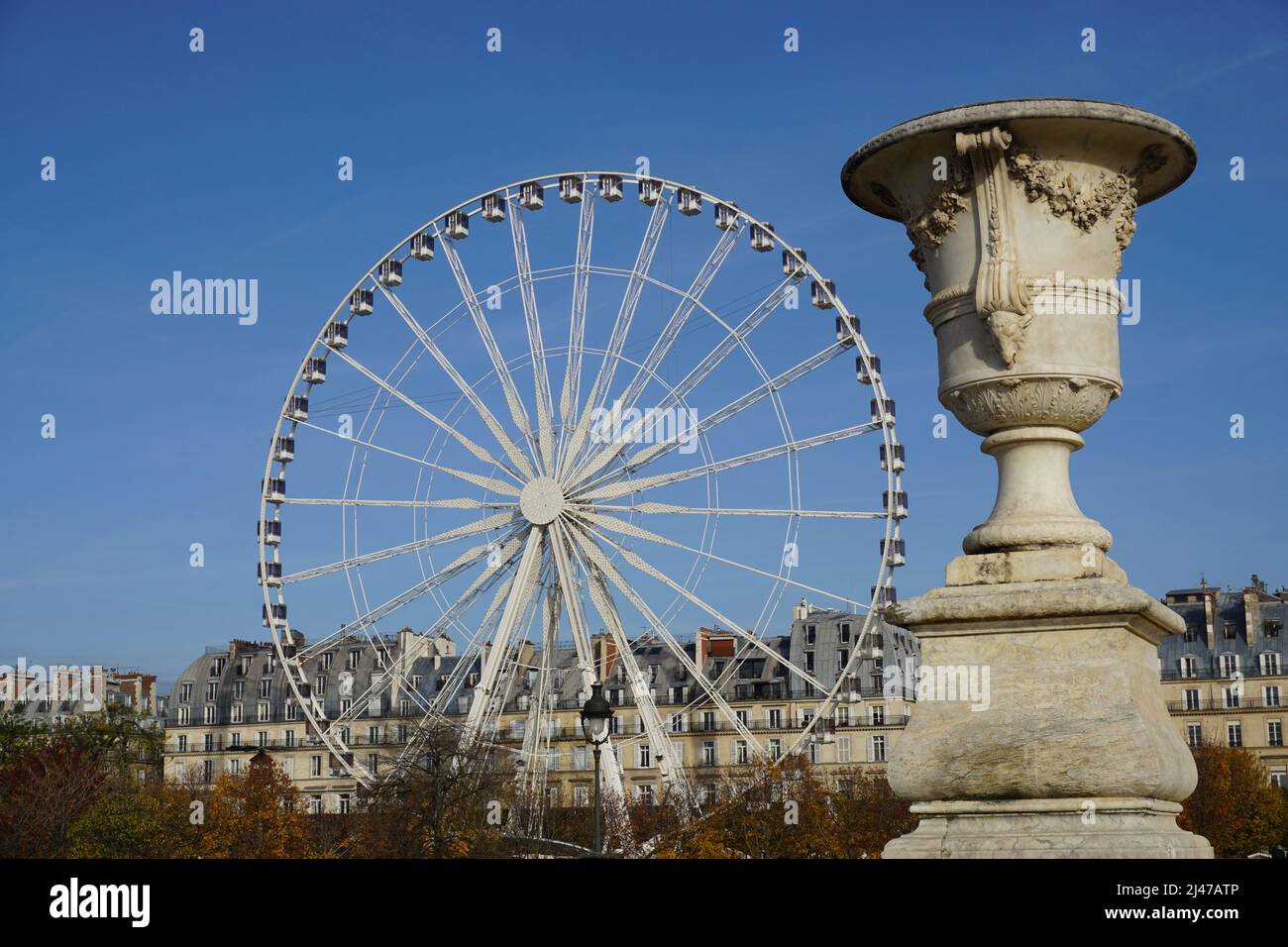 view of the big ferris wheel in Jardin des Tuileries in downtown Paris ...
