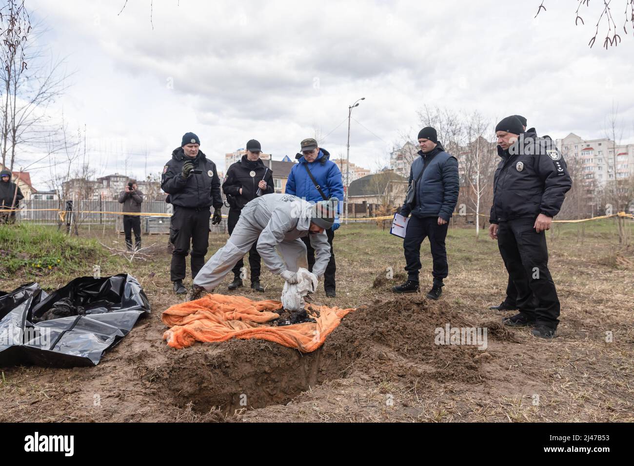 (EDITOR'S NOTE: Image depicts death) Forensic police officers exhume ...