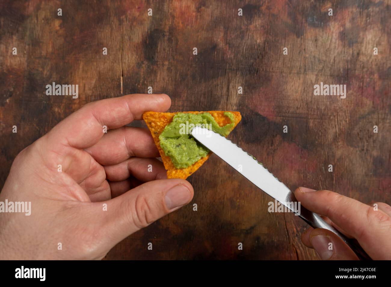 Avocado puree. Spread chopped avocado on a triangle of corn. Healthy ...