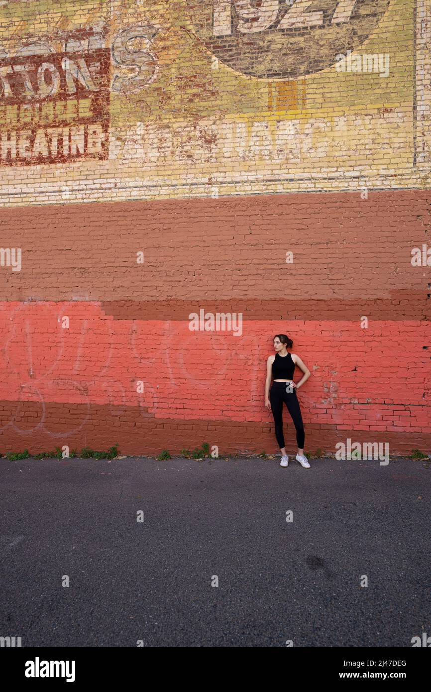 Teenage Female Dancer Standing by Painted Brick Building in Downtown ...