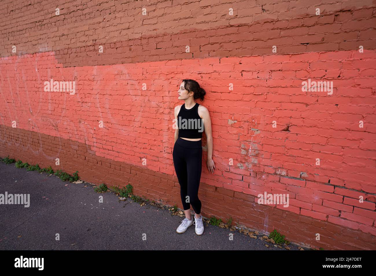 Teenage Female Dancer Standing by Painted Brick Building in Downtown ...