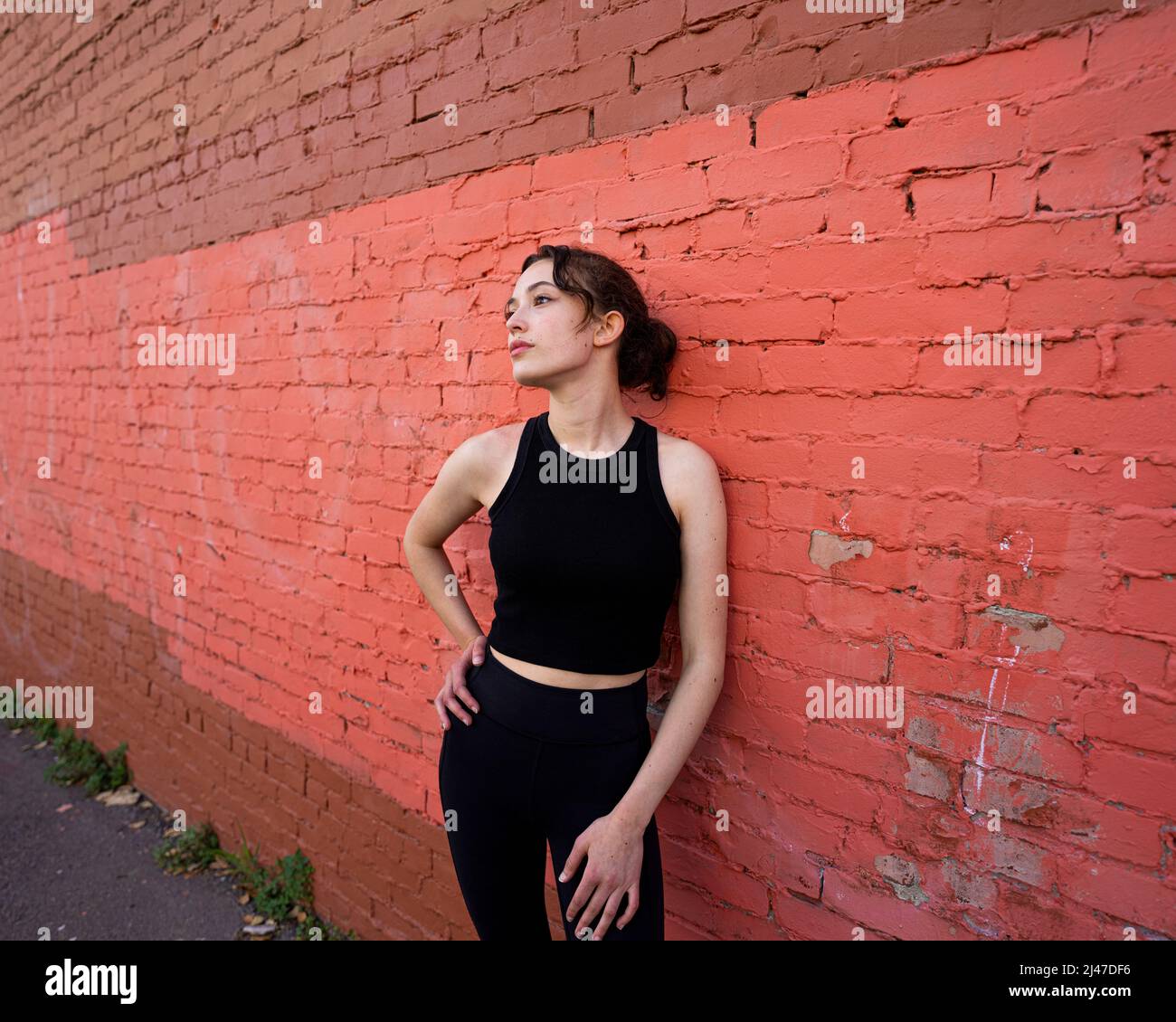 Teenage Female Dancer Standing by Painted Brick Building in Downtown ...