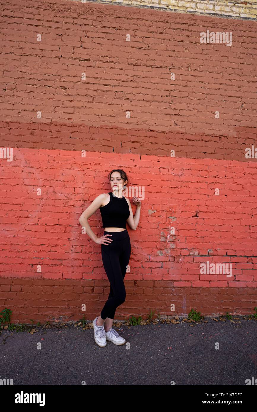 Teenage Female Dancer Standing by Painted Brick Building in Downtown ...
