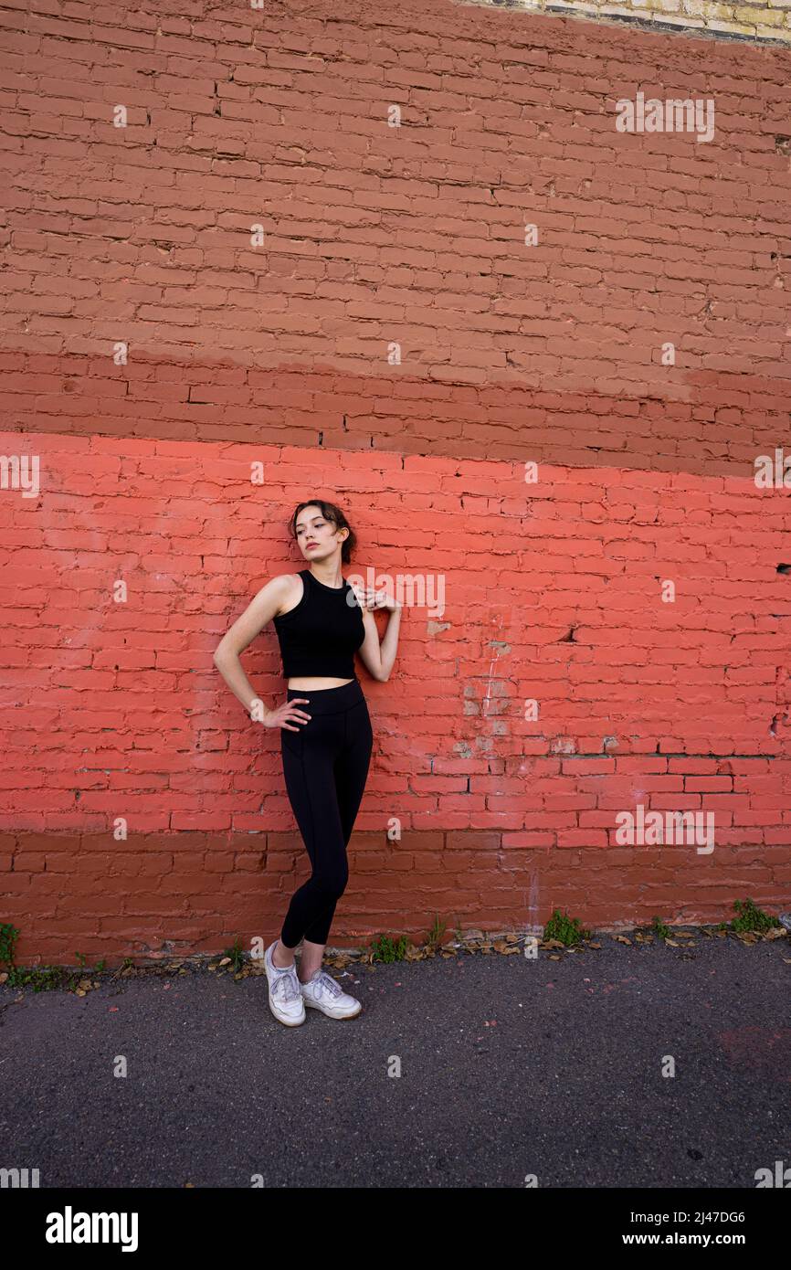 Teenage Female Dancer Standing by Painted Brick Building in Downtown ...