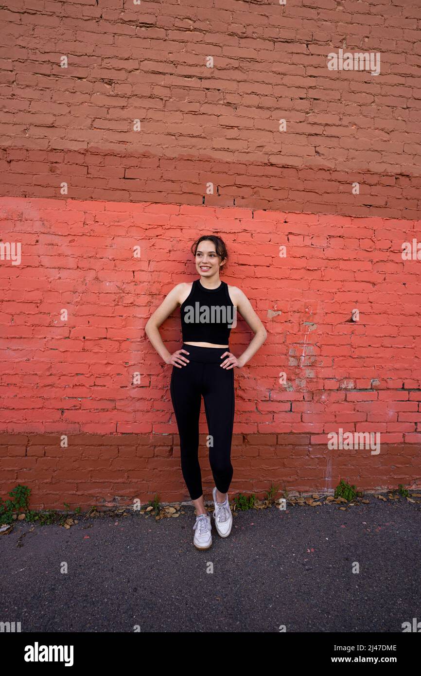 Teenage Female Dancer Standing by Painted Brick Building in Downtown ...