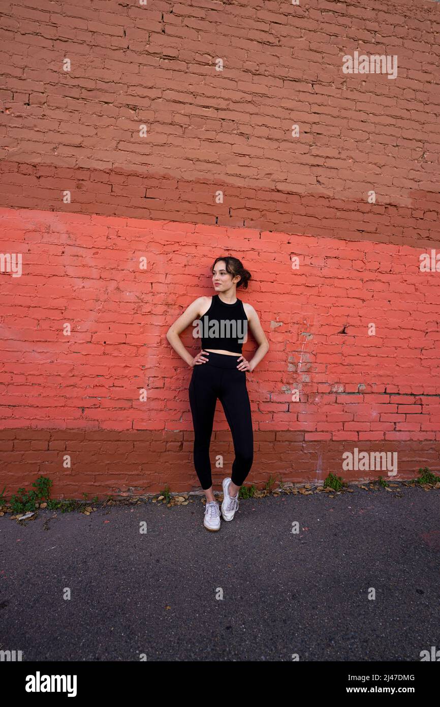 Teenage Female Dancer Standing by Painted Brick Building in Downtown ...