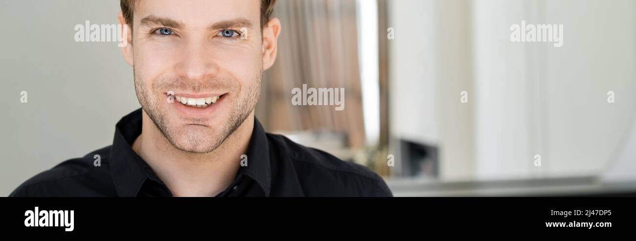 portrait of young man smiling at camera at home, banner Stock Photo - Alamy