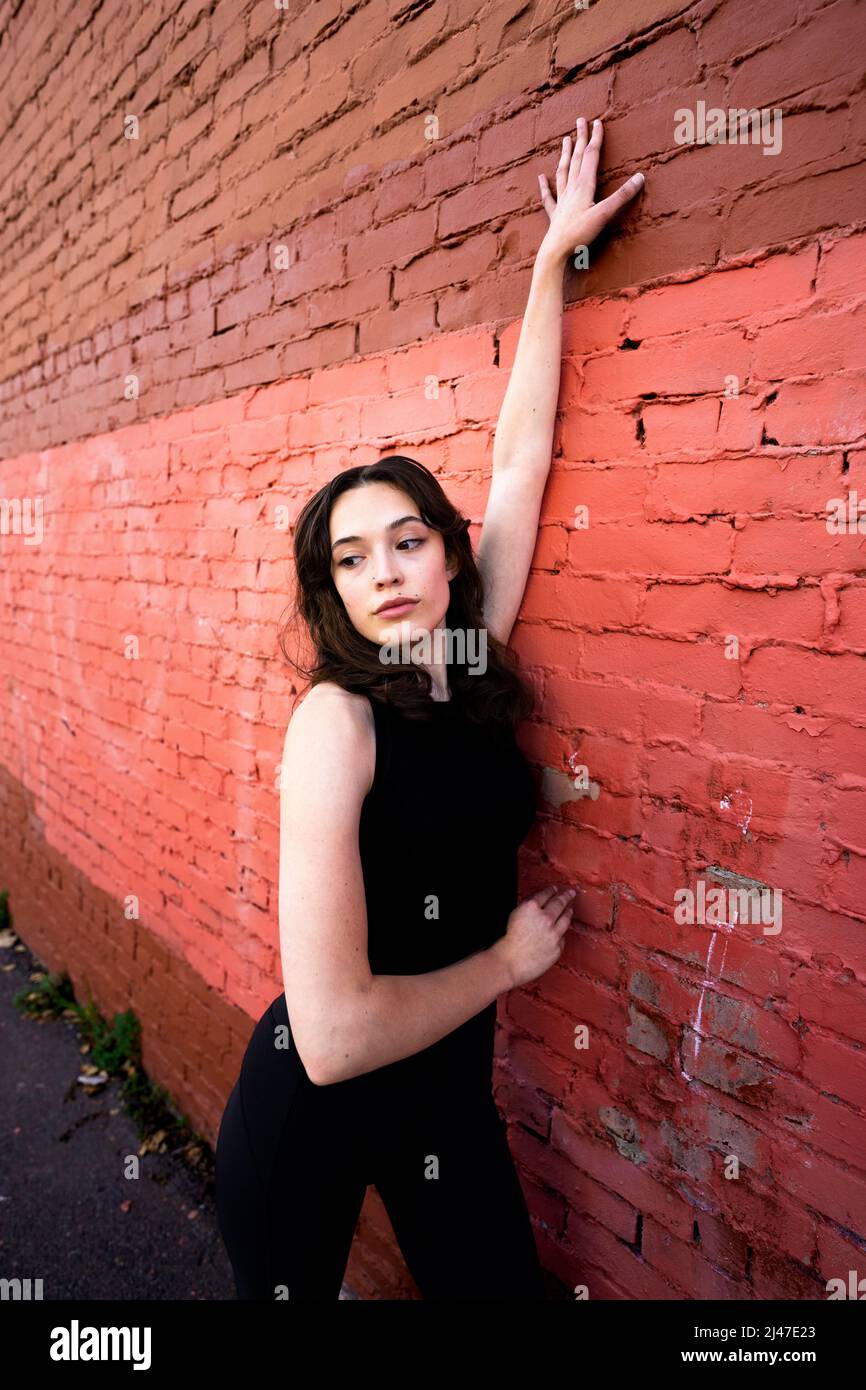 Teenage Female Dancer Standing by Painted Brick Building in Downtown ...