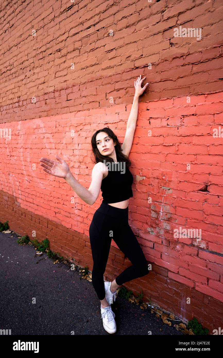 Teenage Female Dancer Standing by Painted Brick Building in Downtown ...