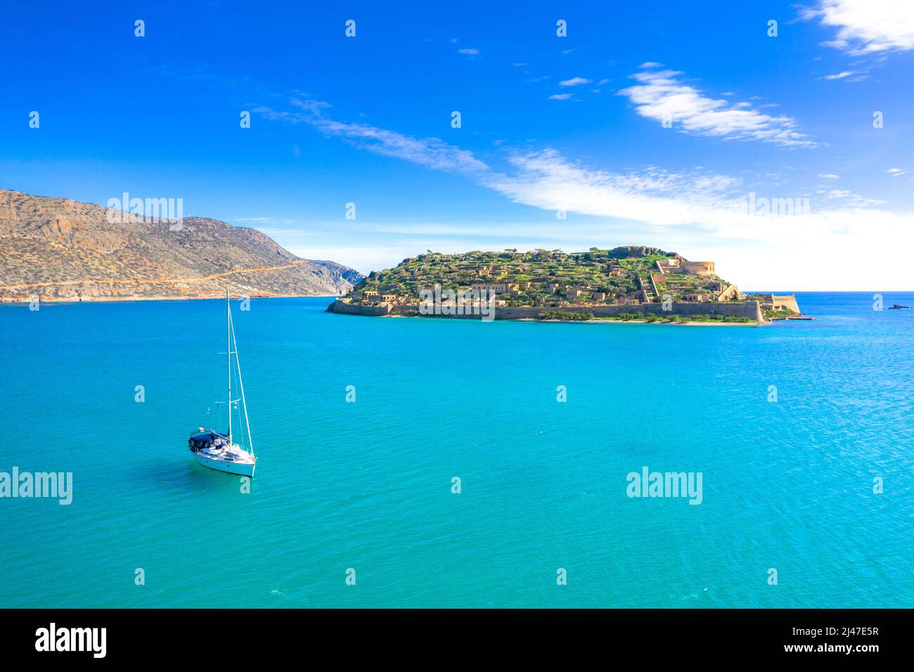 View of the island of Spinalonga with calm sea. Here were isolated ...