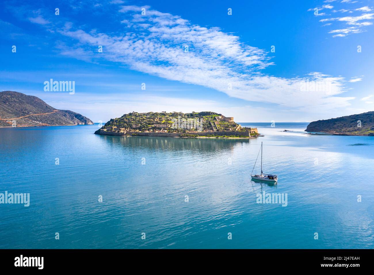 View of the island of Spinalonga with calm sea. Here were isolated ...