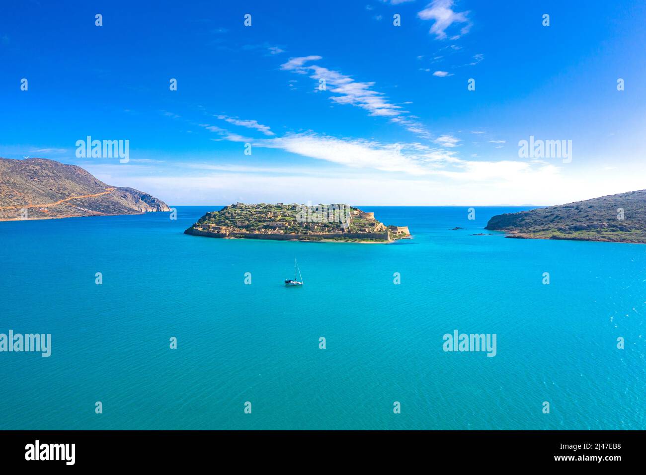 View of the island of Spinalonga with calm sea. Here were isolated ...