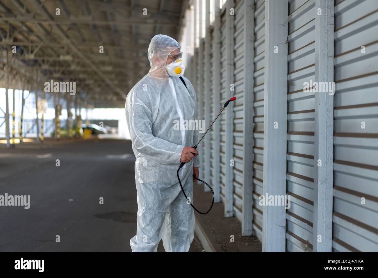 Worker wearing protective suit disinfection gear disinfect surface ...