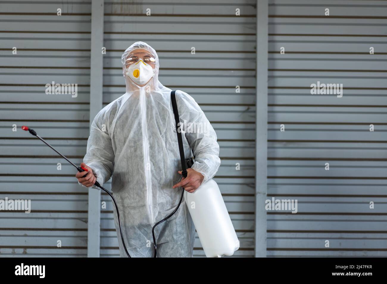Worker wearing protective suit disinfection gear disinfect surface ...