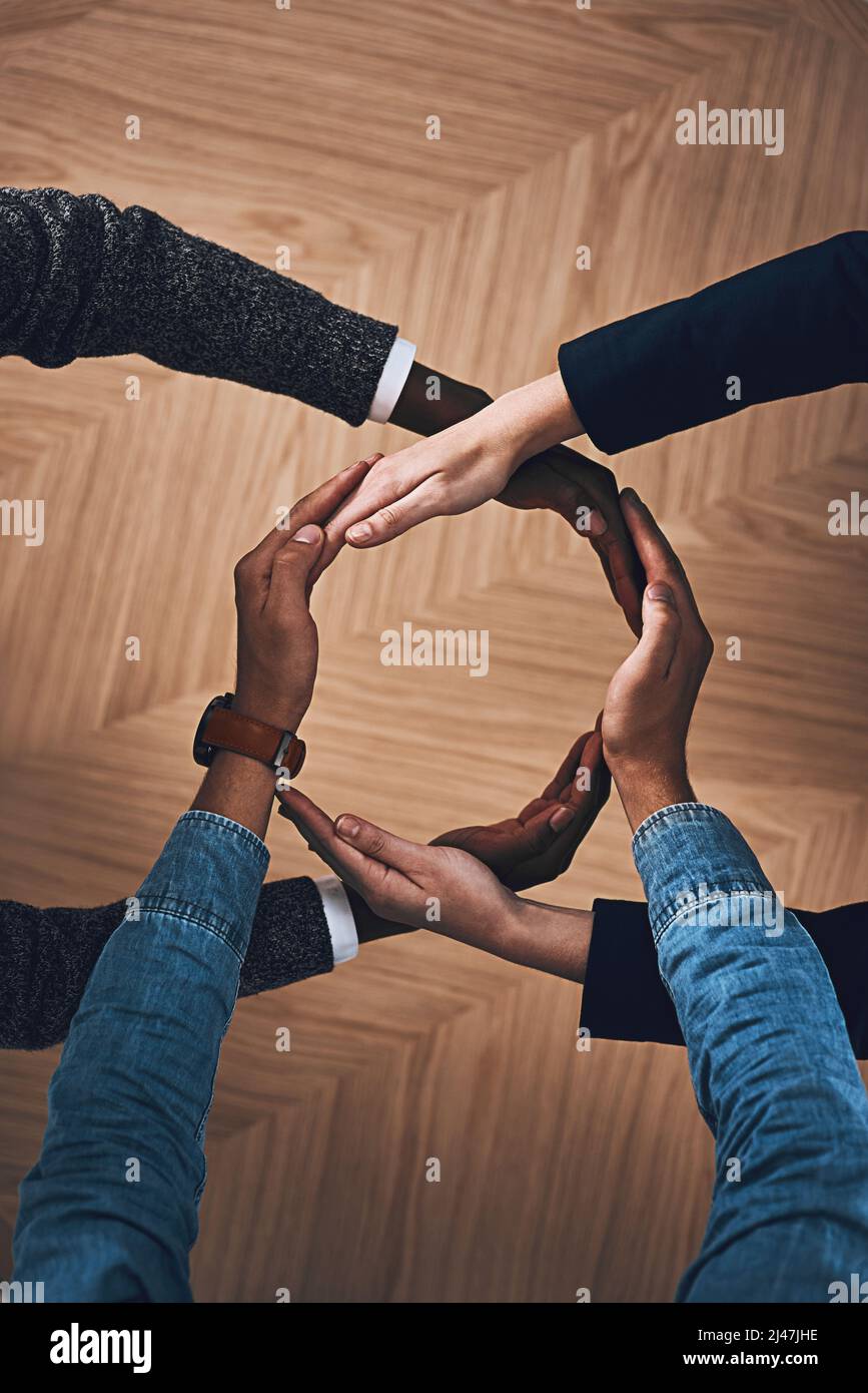 There is more power in unity than division. High angle shot of a group ...