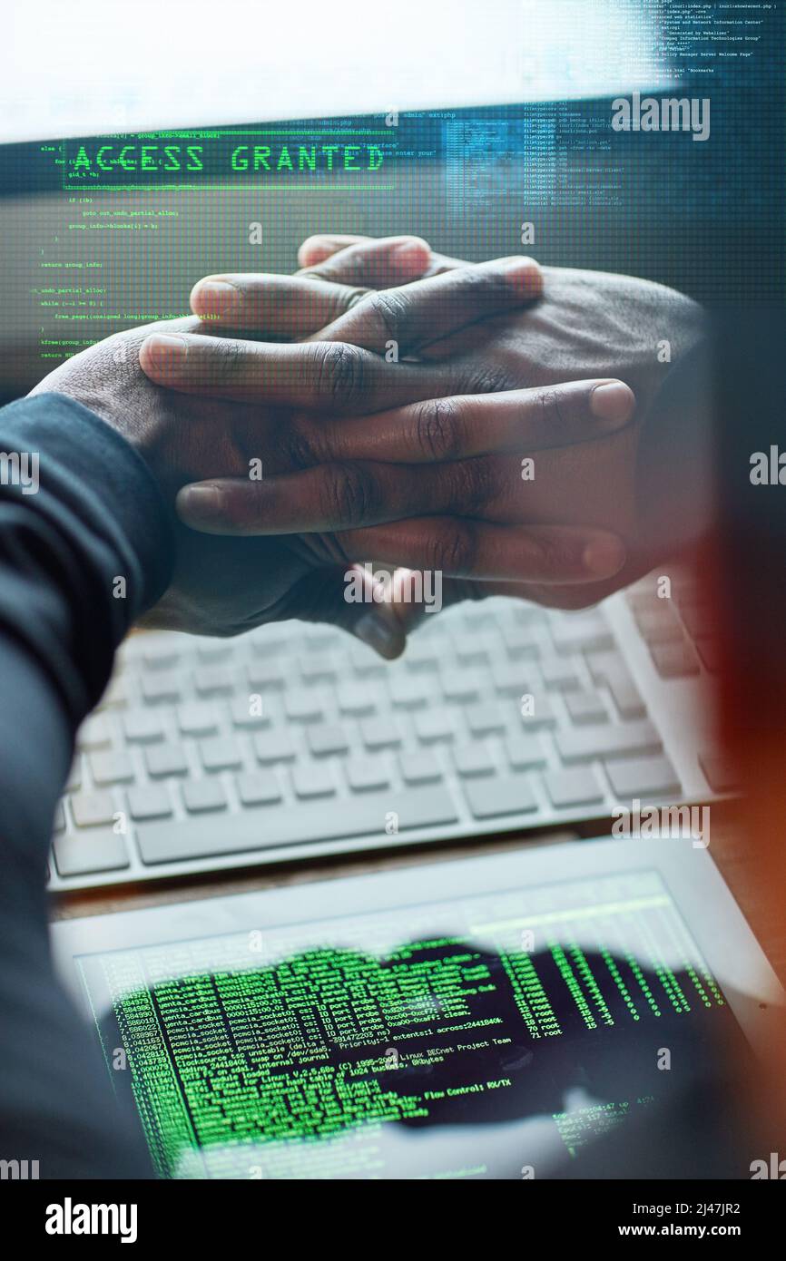 It feels so good to be bad. Cropped shot of an unidentifiable hacker cracking a computer code in ...