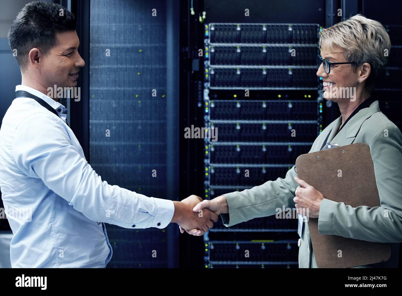 Always a pleasure programming with you. Shot of two technicians shaking ...