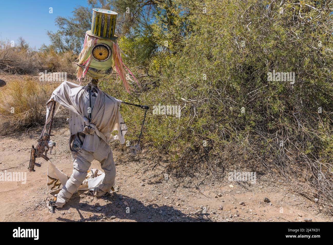 Freakish creature sculpture with one large, orange eye, multicolored ...