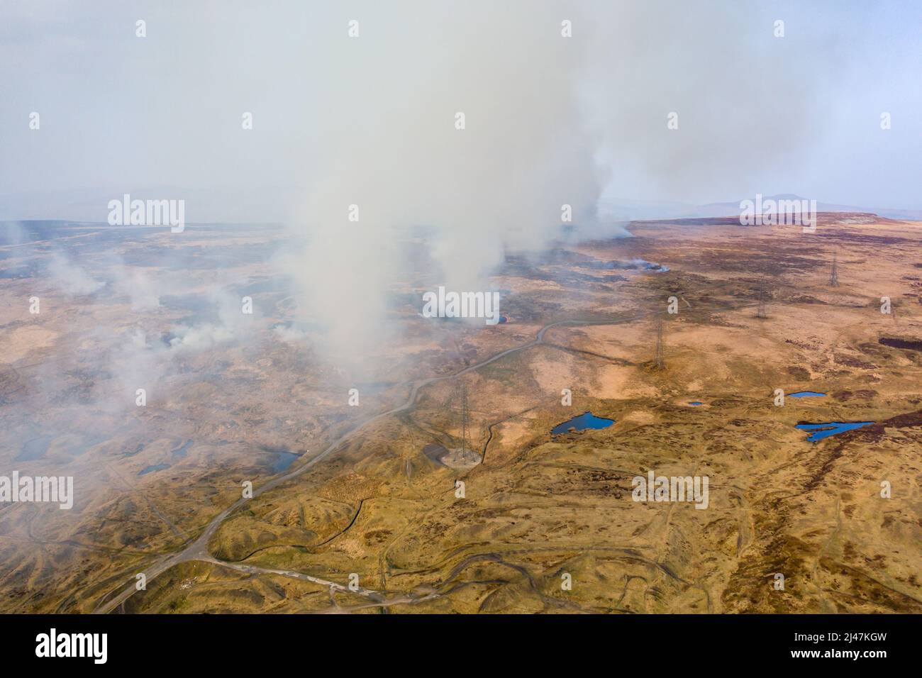Aerial view of a huge wildfire on higher level moorland next to a ...