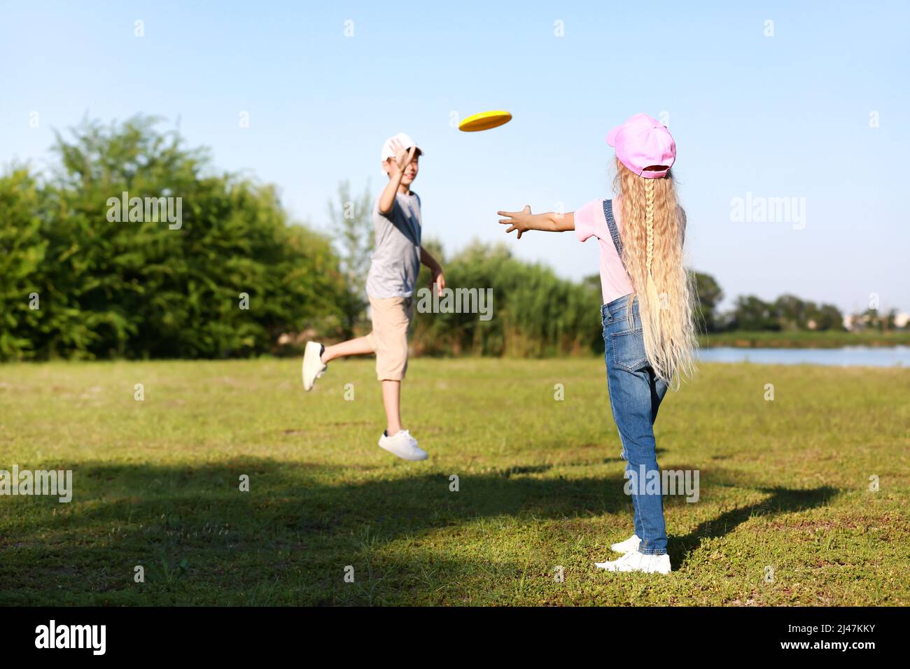 Cute little children playing frisbee outdoors Stock Photo - Alamy
