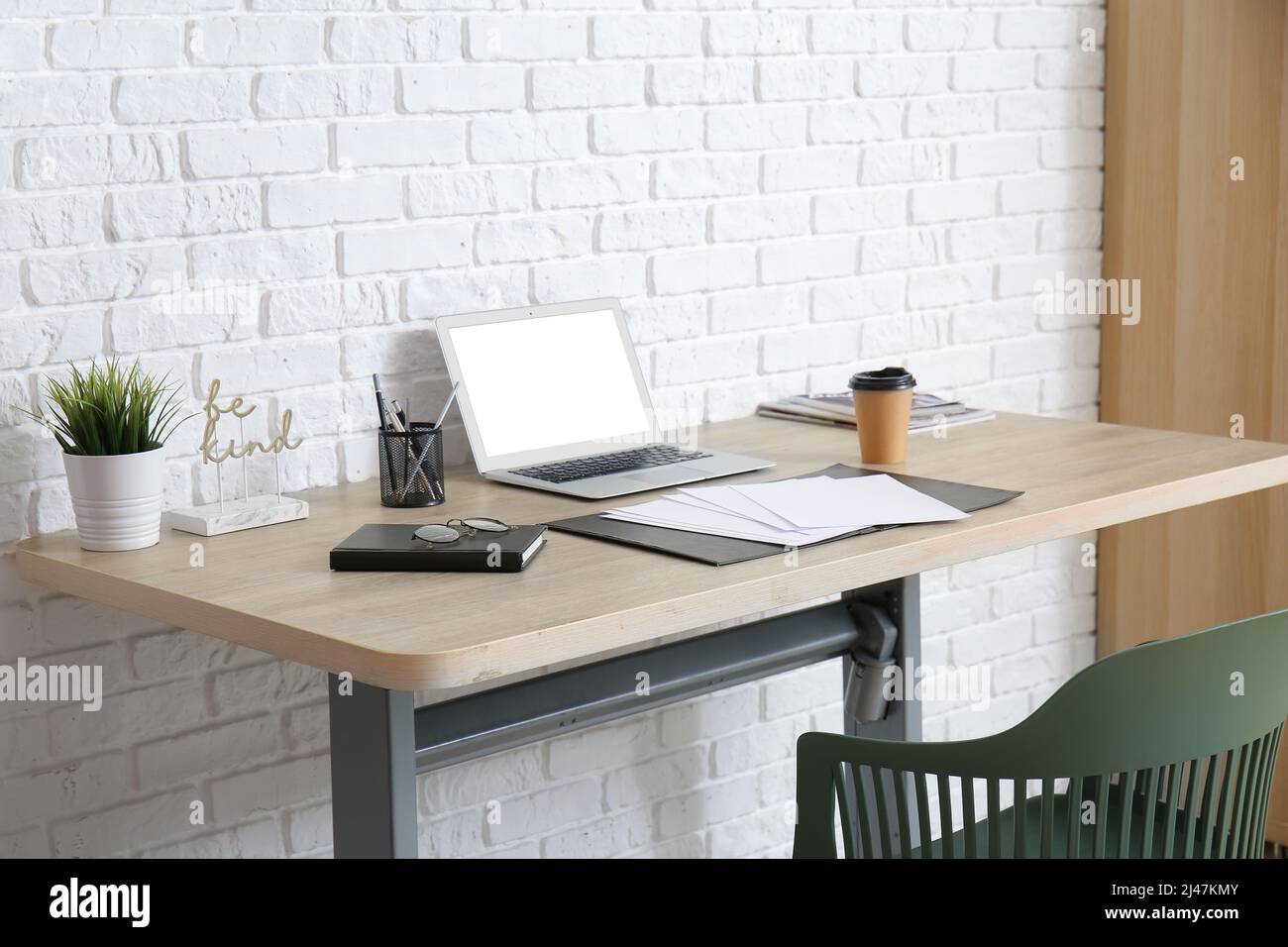 Modern workplace with laptop in room Stock Photo - Alamy