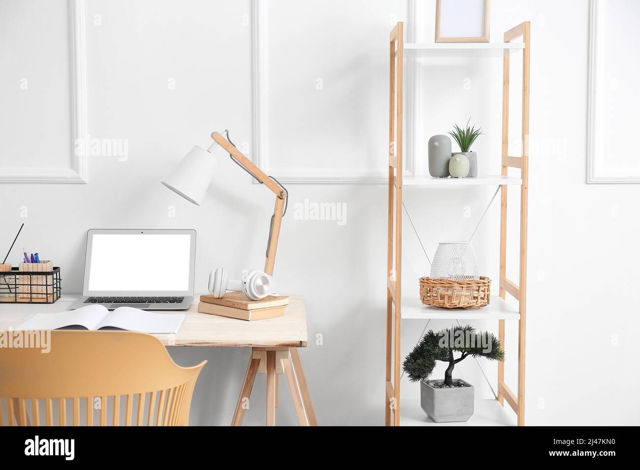 Modern workplace with laptop in room Stock Photo - Alamy