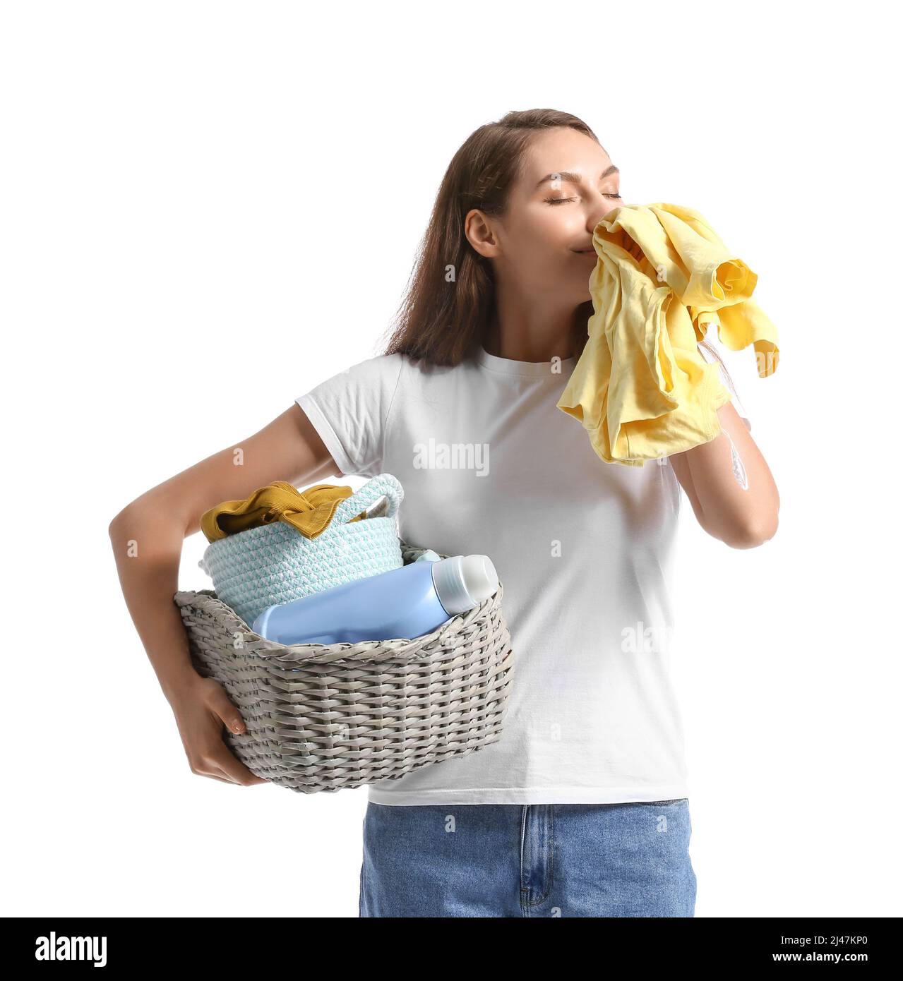 Beautiful woman smelling clean laundry on white background Stock Photo ...