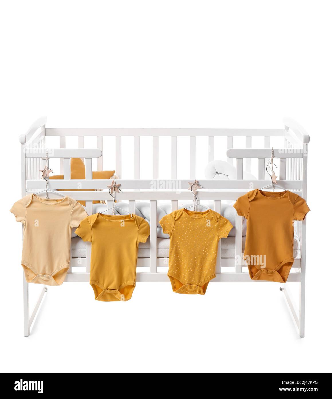 Baby crib with bodysuits on white background Stock Photo - Alamy