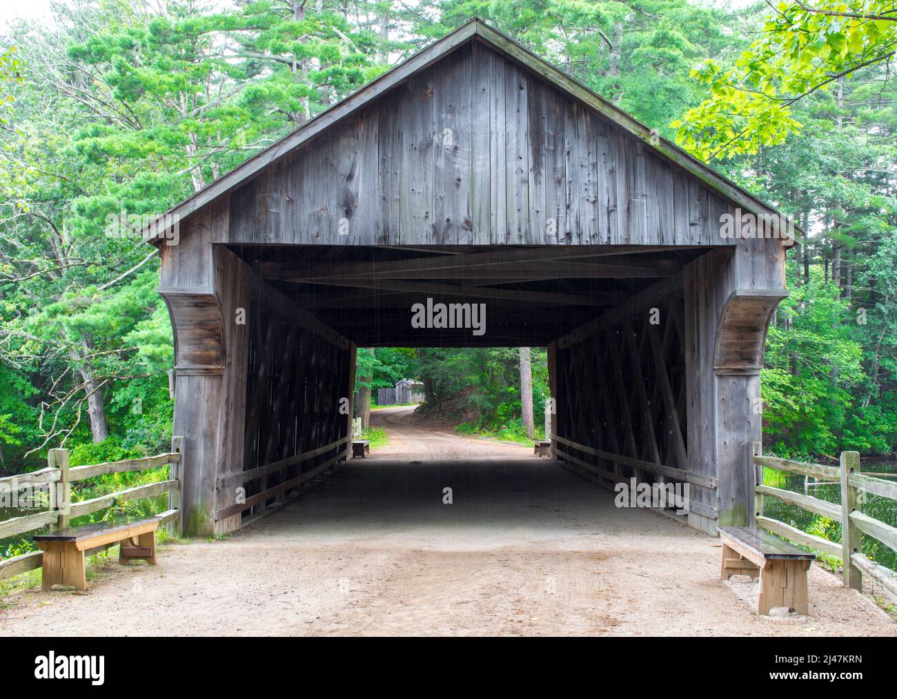 vintage colonial wooden covered bridge in Sturbridge MA USA on a rainy ...