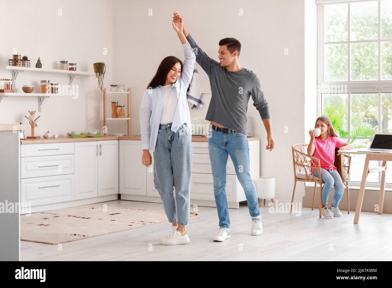 Happy couple dancing in kitchen Stock Photo - Alamy